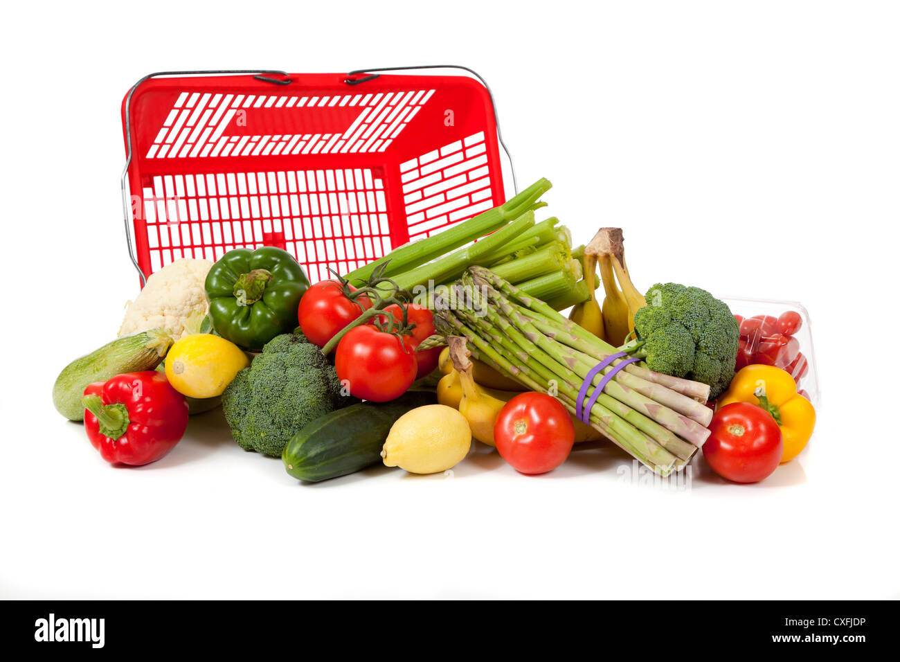 Red plastic shopping basket with fresh vegetables on a white background ...