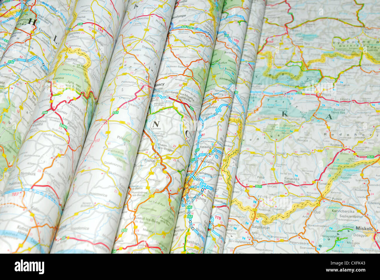 Various colorful road maps folded Stock Photo - Alamy