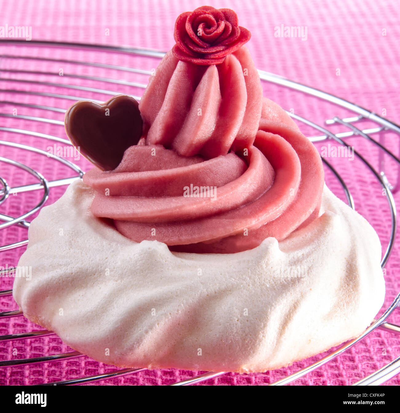 meringue with raspberry buttercream, chocolate heart and red rose Stock ...