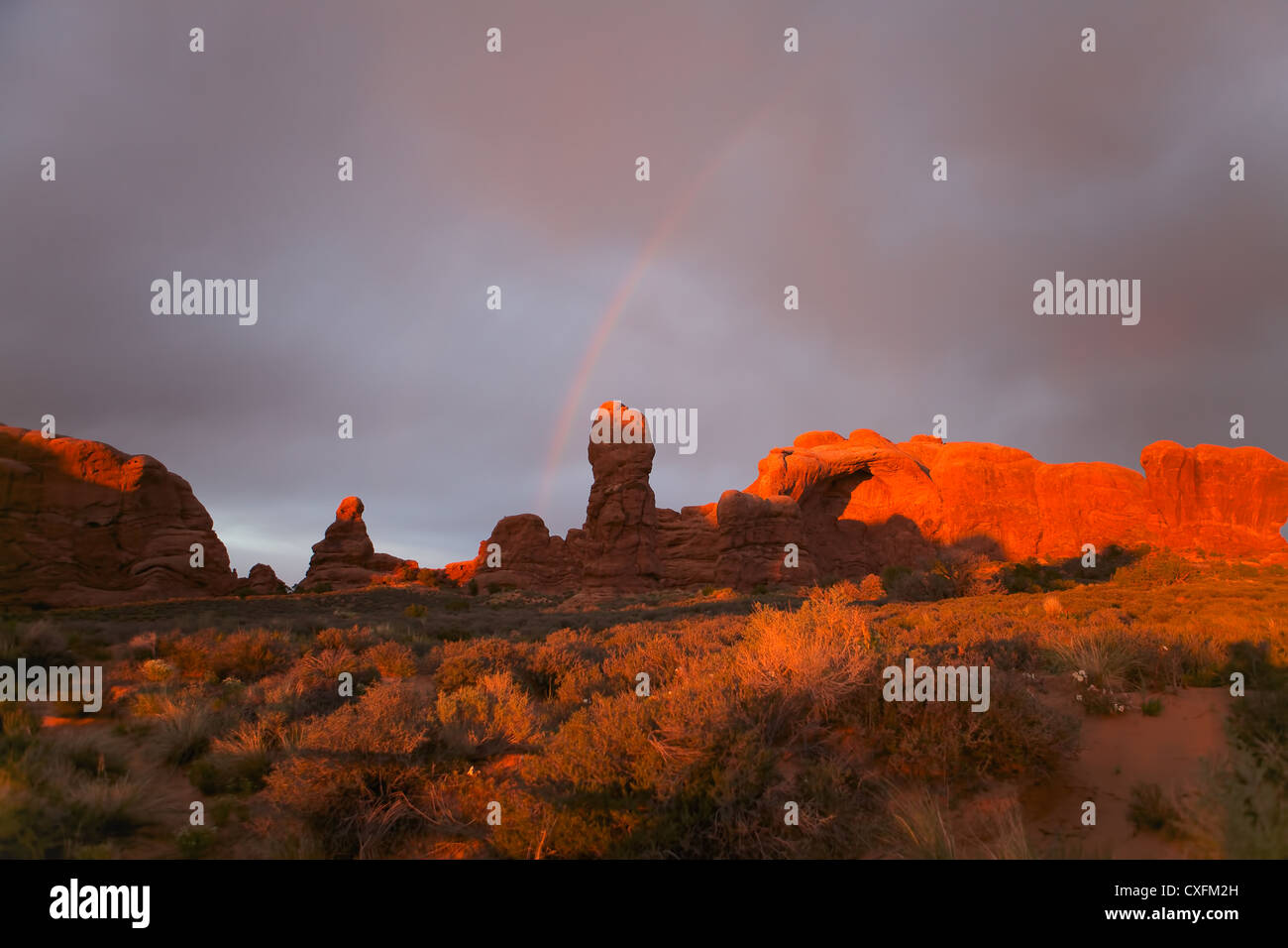 Landscape in Arches National Park at sunset with a rainbow, Utah, USA ...