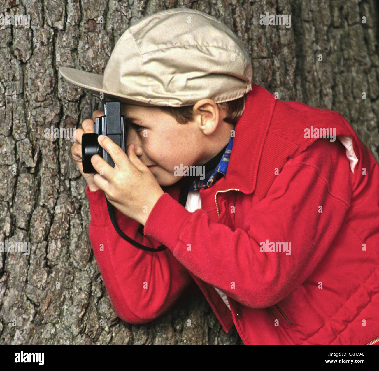 A child boy with a camera taking photographs Stock Photo - Alamy