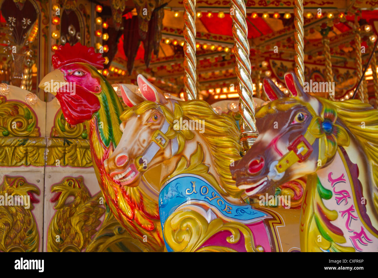A cockerel and 2 horses racing around on a steam powered fairground ...