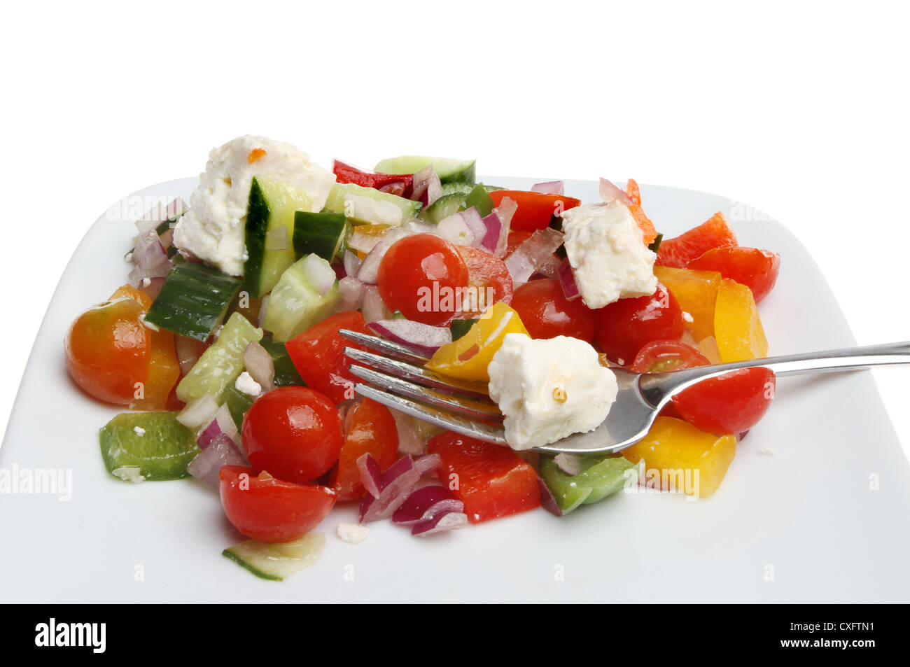 Greek salad with a fork on a plate against a white background Stock ...