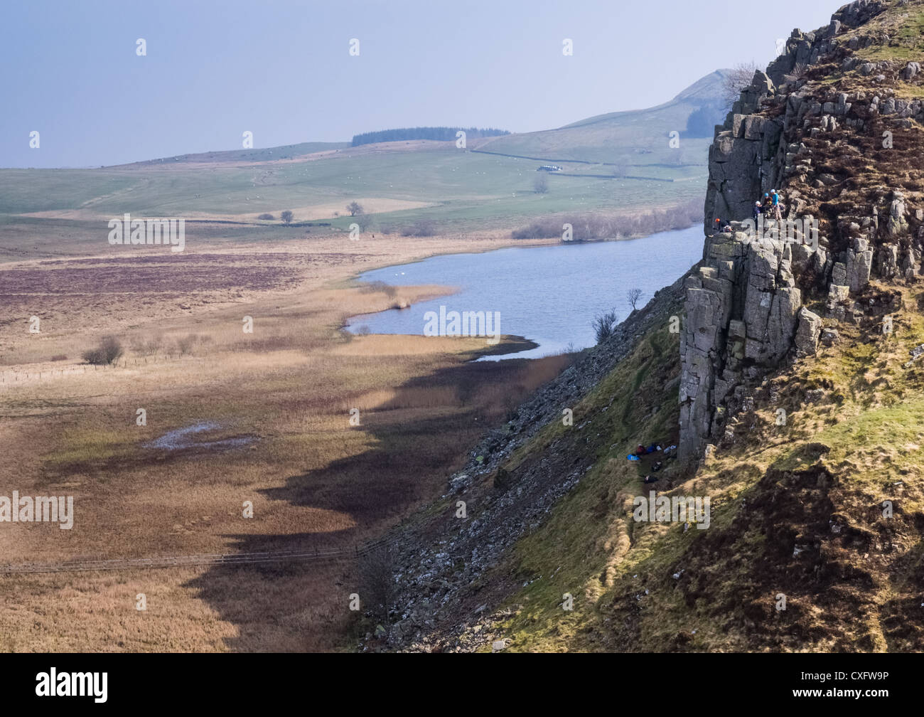 Climbers ascending the crag that forms part of the Whin sill that runs ...