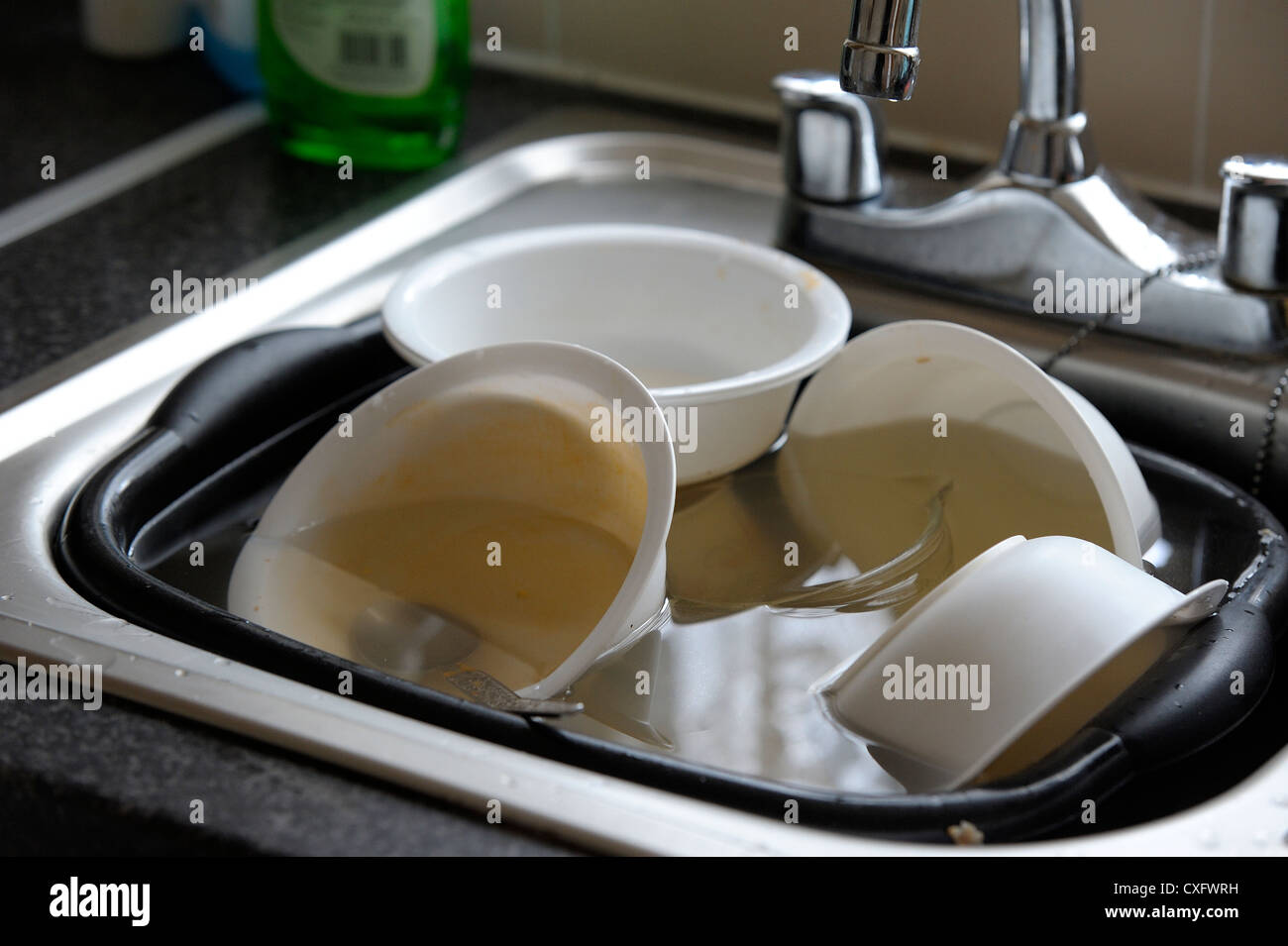 dirty pots piling up in a sink Stock Photo - Alamy