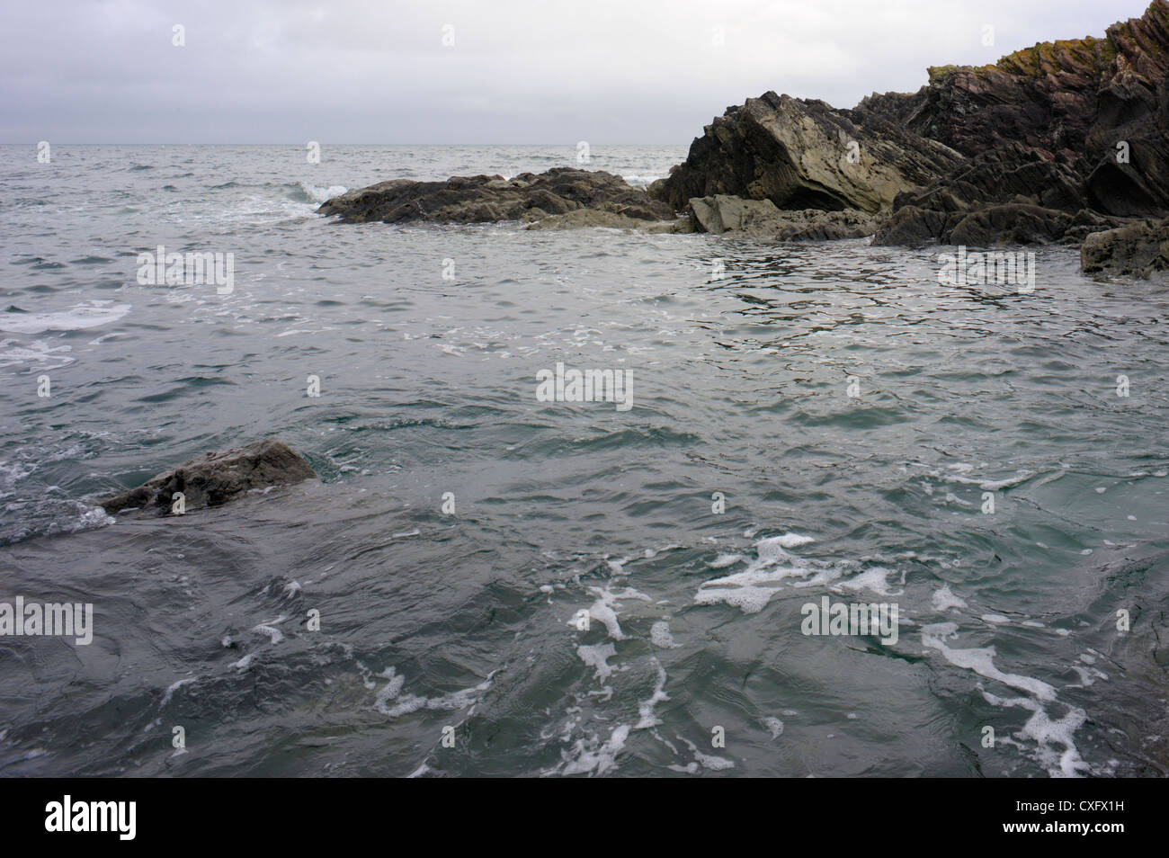 Grey Sea with rocks Stock Photo - Alamy