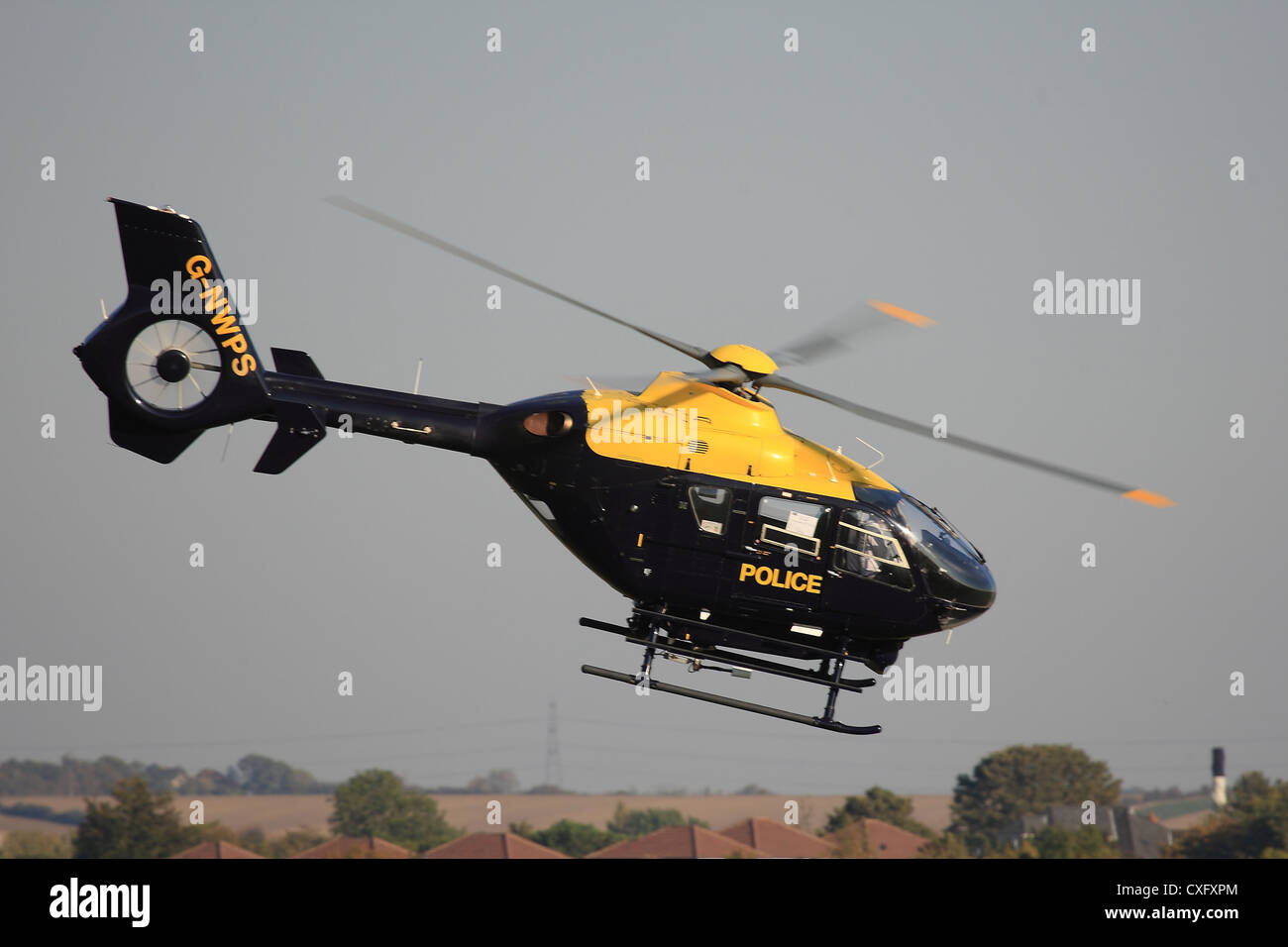 G-NWPS EC-135 Police helicopter swoops low over a field Stock Photo - Alamy