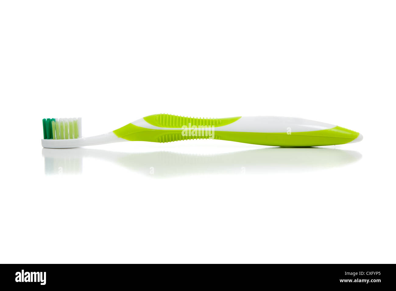 Green toothbrush on a white background Stock Photo - Alamy