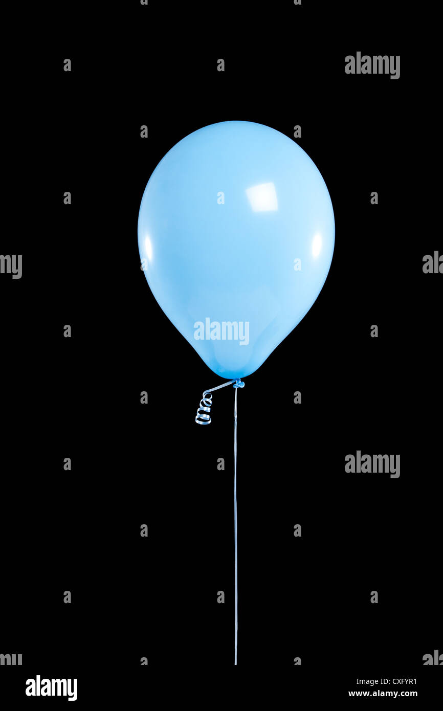 Single light blue balloon on a black background Stock Photo - Alamy