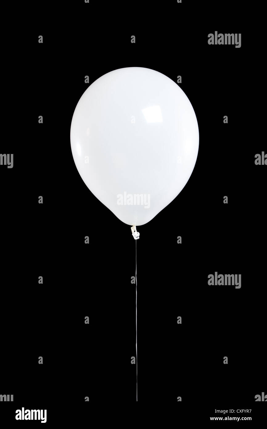 Single white balloon on a black background Stock Photo - Alamy