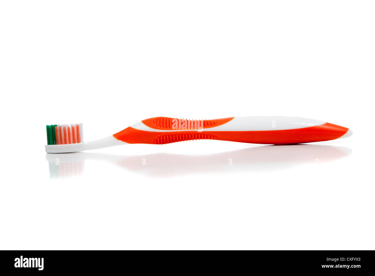 Orange toothbrush on a white background Stock Photo - Alamy
