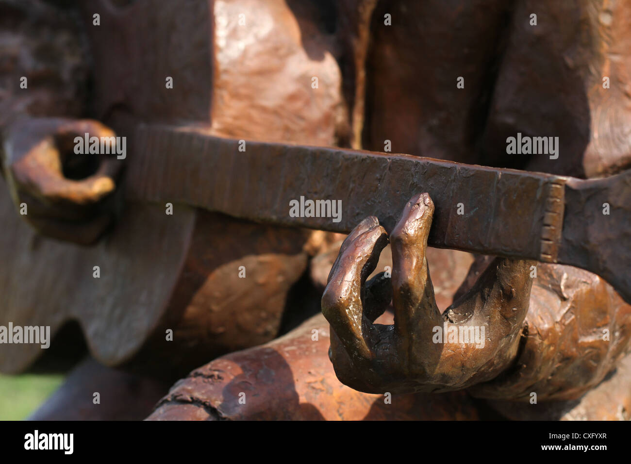 A close up of a statue of a person playing guitar at Big Stone Mini ...
