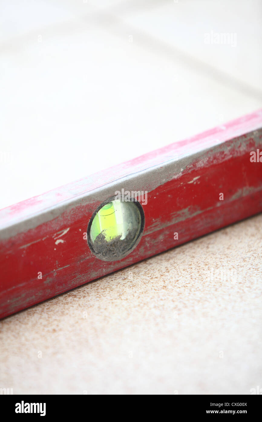 level Construction worker is tiling at home, tile floor adhesive Stock ...