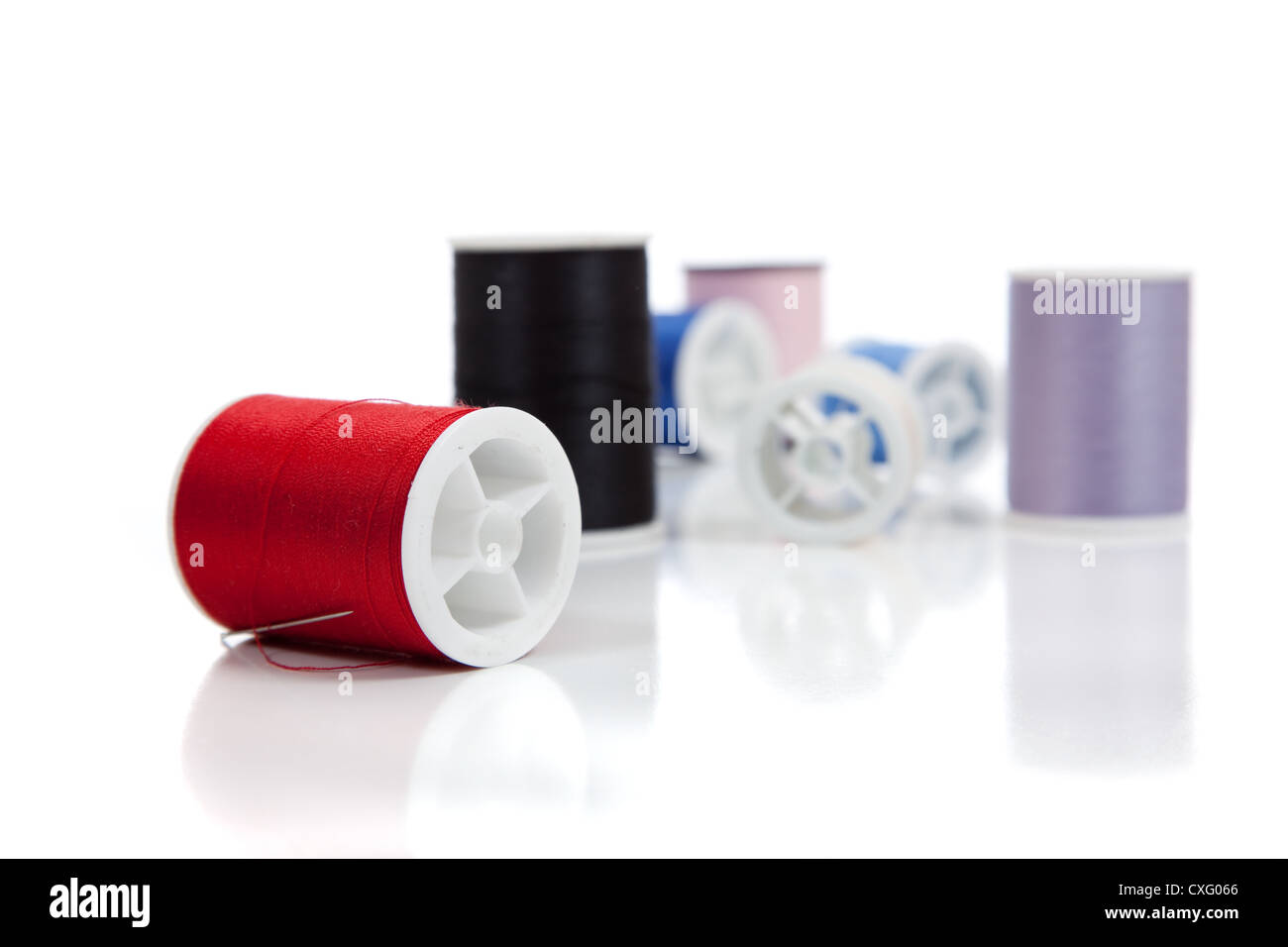 Row of various colored spools of thread Stock Photo - Alamy
