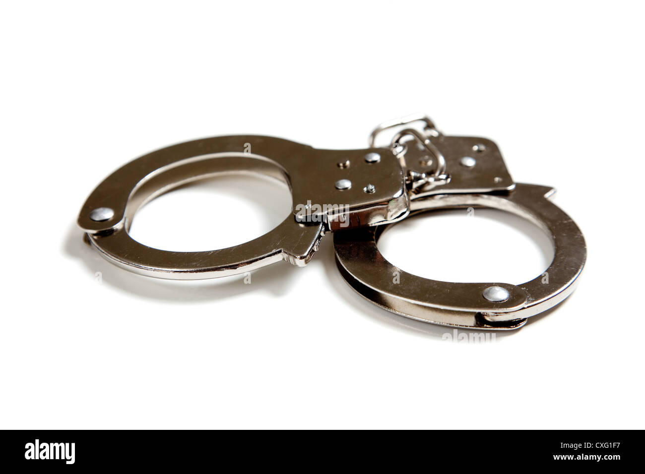 Silver handcuffs on a white background Stock Photo - Alamy