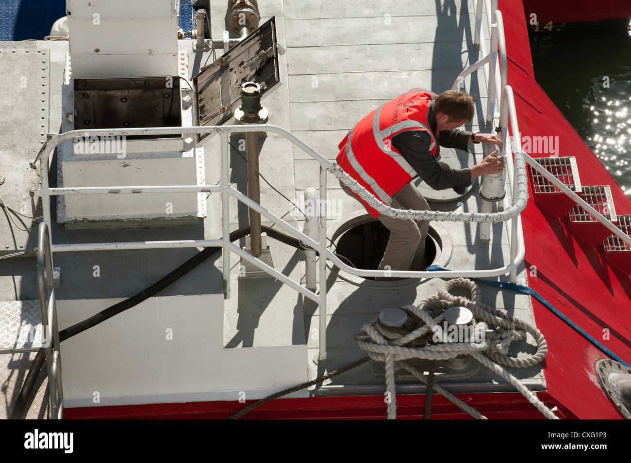 Ships' engineer climbing into the engine room of a commercial passenger ...