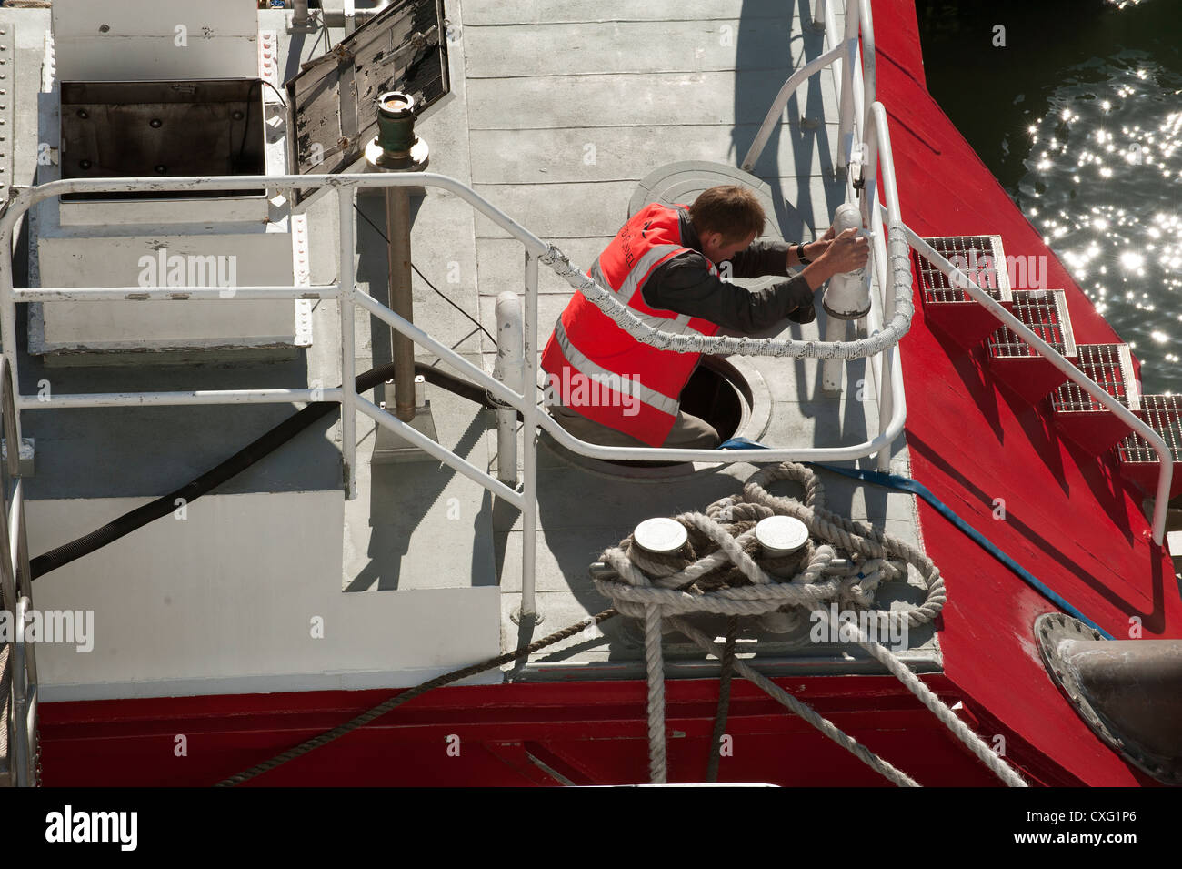Ships' engineer climbing into the engine room of a commercial passenger ...