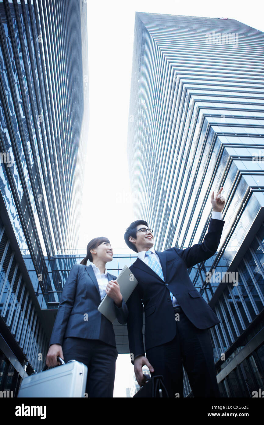 A business man watching in the direction the woman is pointing Stock ...