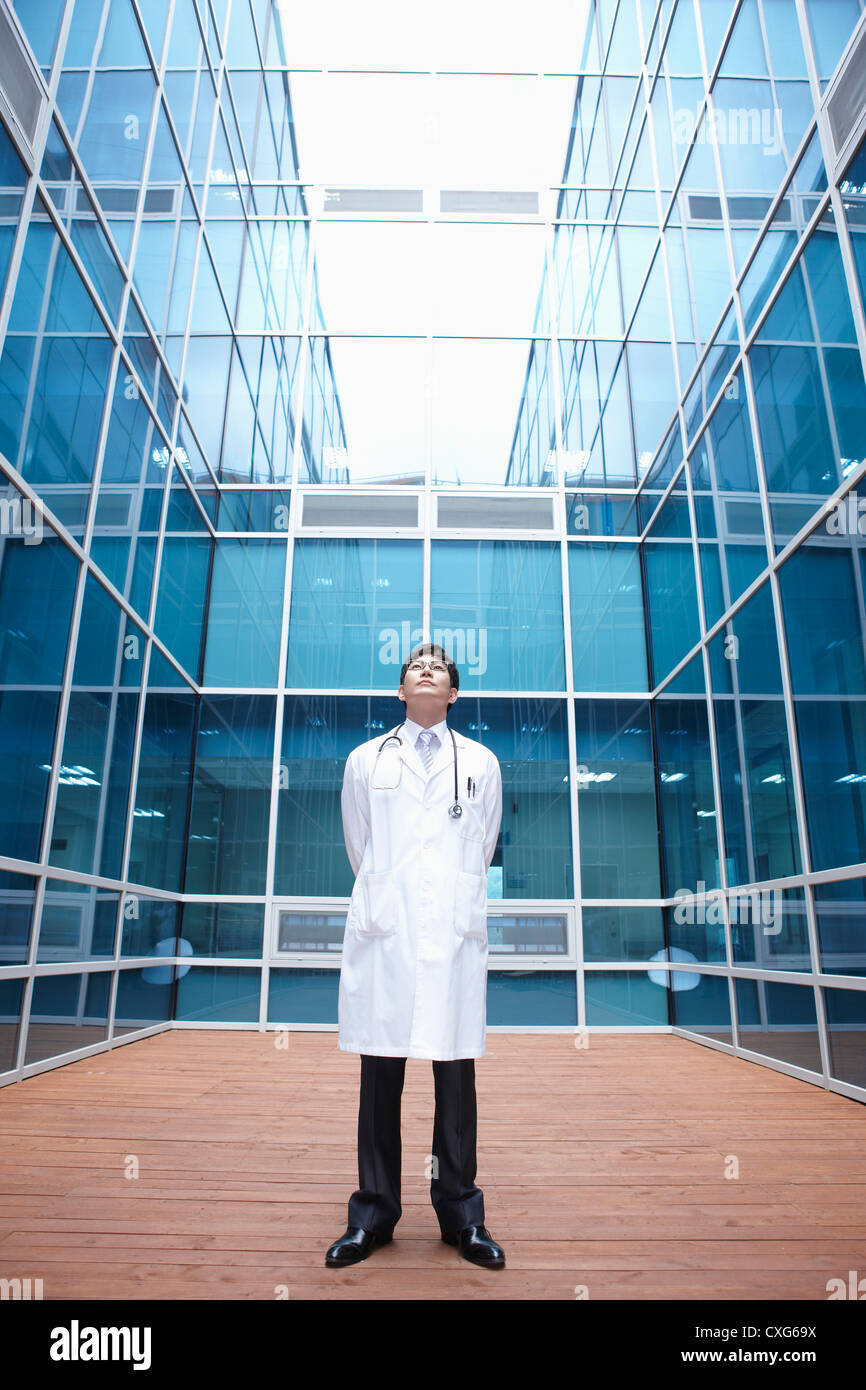 A doctor standing in middle of a modern building Stock Photo - Alamy