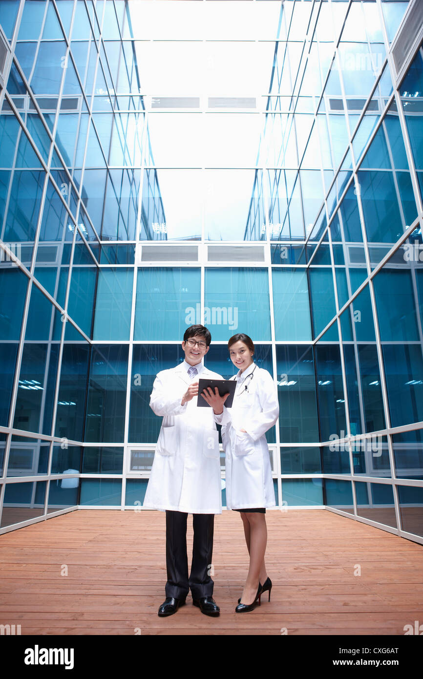 Doctors standing in a modern building Stock Photo - Alamy