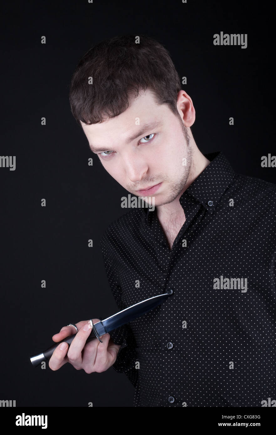Anger man with knife look from dark Stock Photo - Alamy