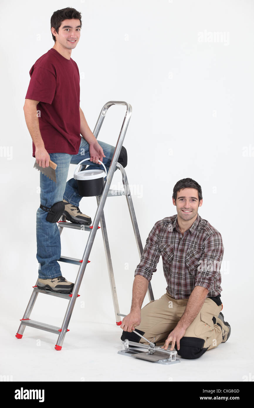 duo of tilers working hand in hand Stock Photo - Alamy