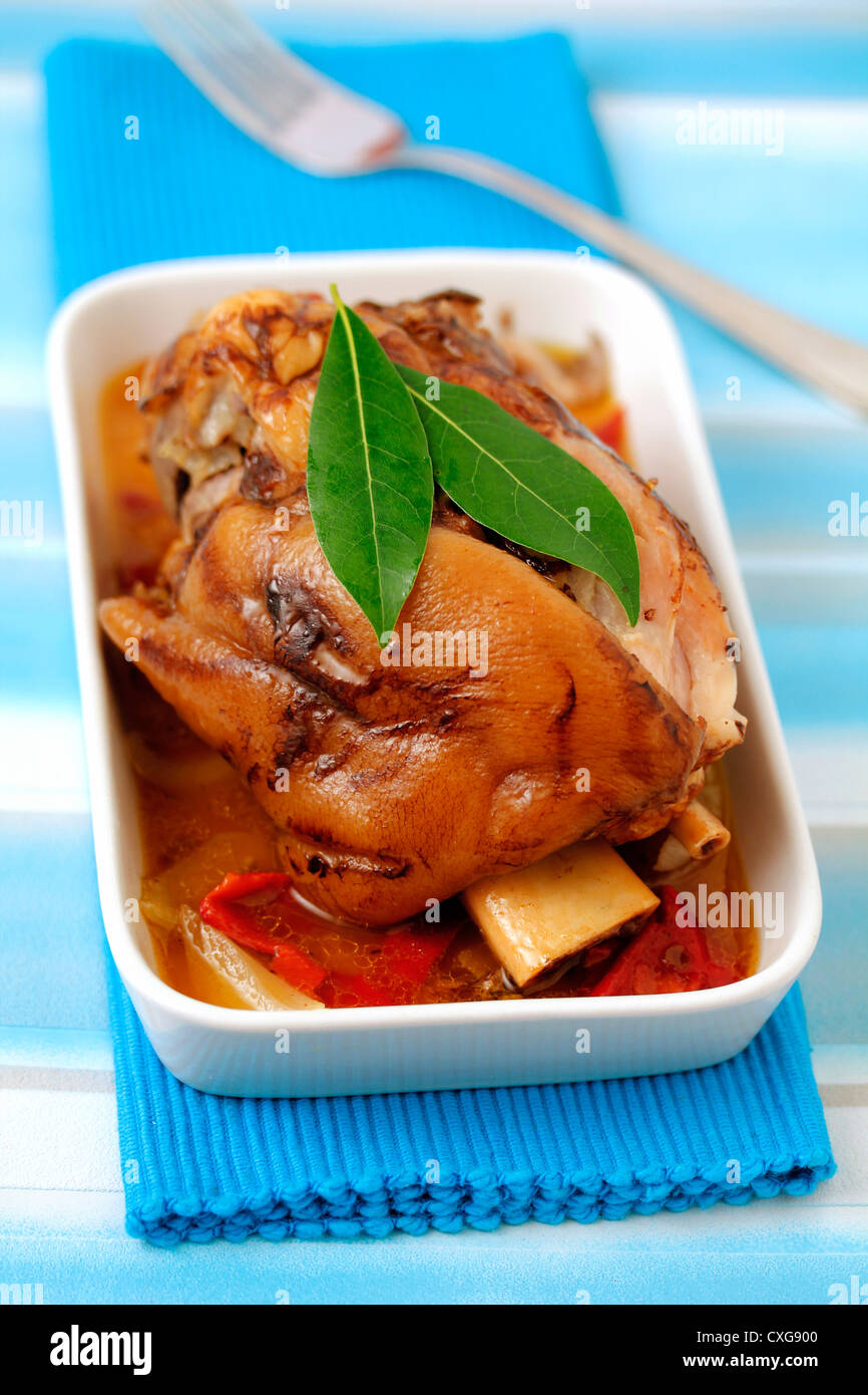 Knuckle with onion and peppers. Recipe available Stock Photo - Alamy