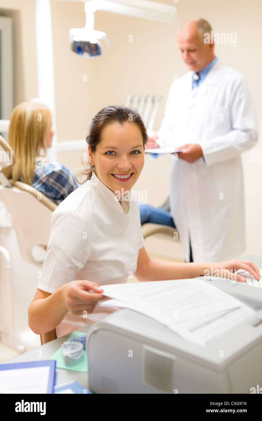 Dental assistant smiling woman prepare patient documentation ...