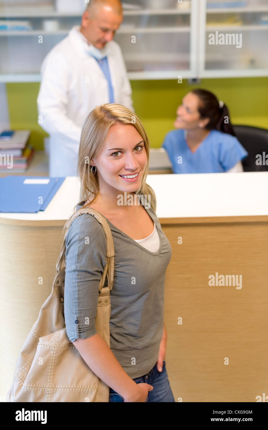 Female patient coming to dental surgery check-up appointment reception ...
