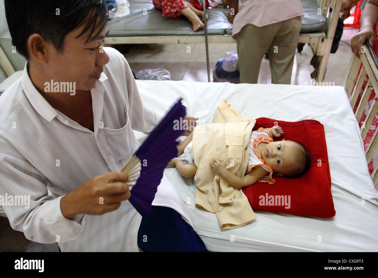 On a children's cancer ward, a father takes care lovingly for his child ...