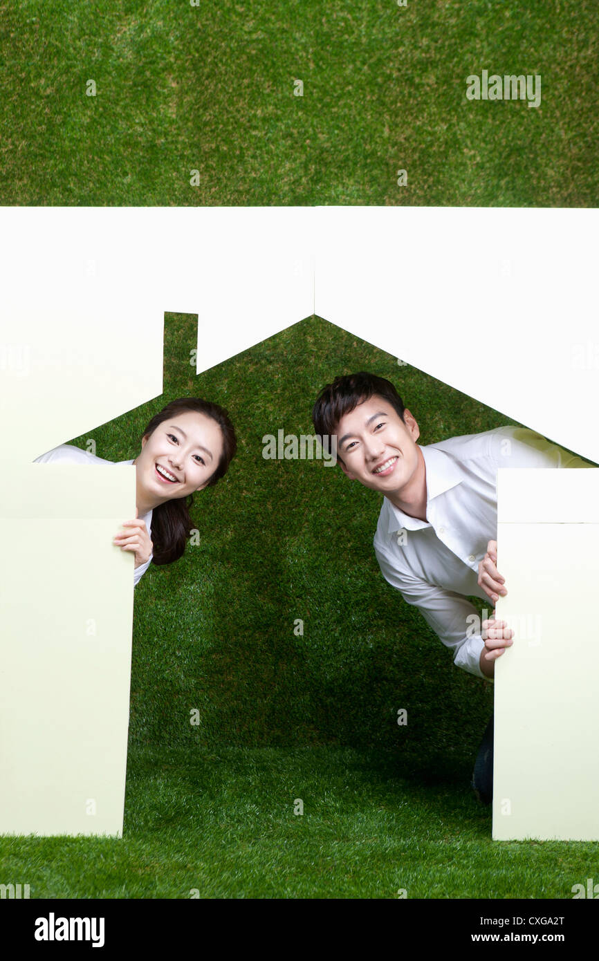 a couple hiding in the paper house Stock Photo - Alamy