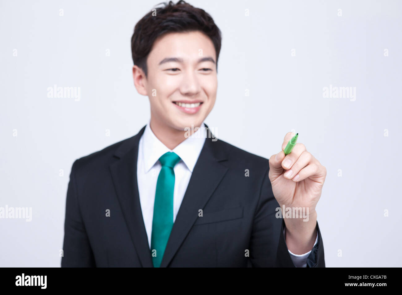 man holding a green pen Stock Photo - Alamy