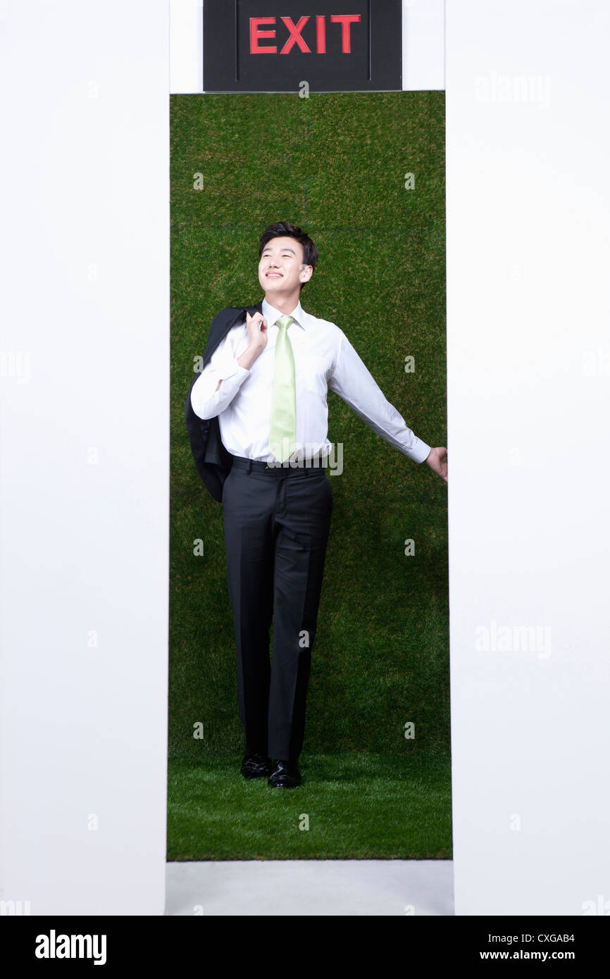 man standing inside the exit with his arm open Stock Photo - Alamy