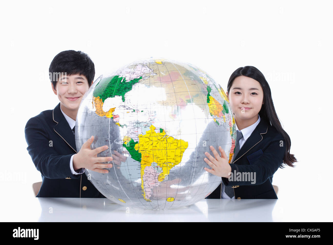 a couple of students holding globe together Stock Photo - Alamy