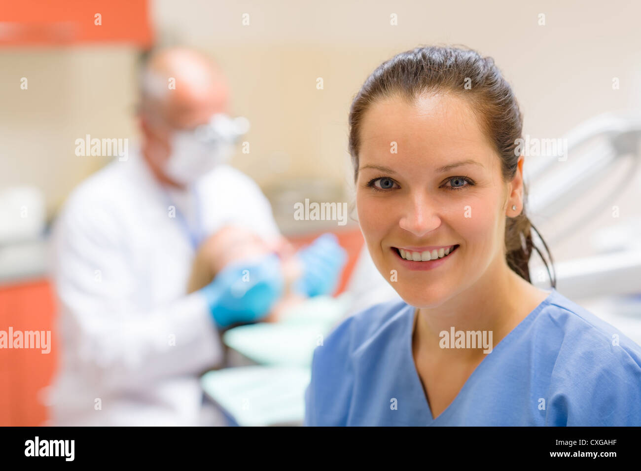 Female dental assistant smiling at stomatology office dentist with ...