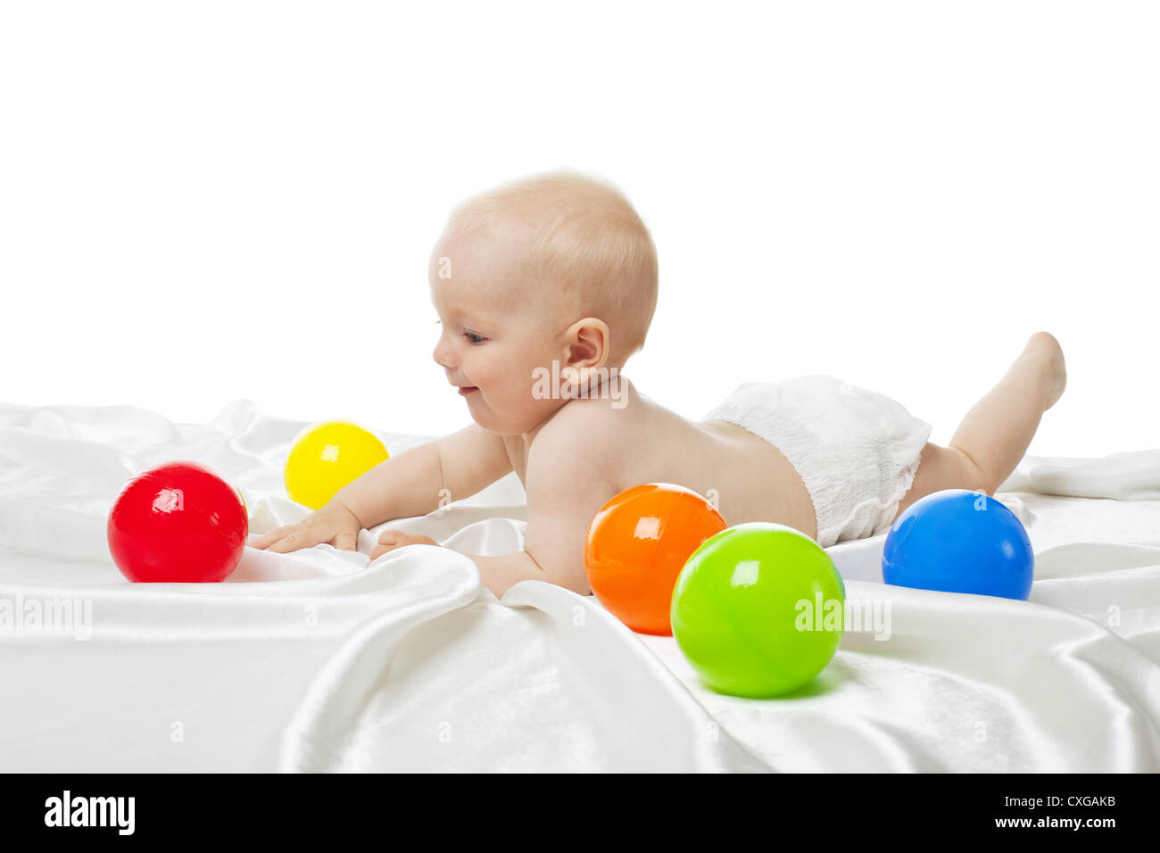 Cute baby play in bed with color balls Stock Photo - Alamy