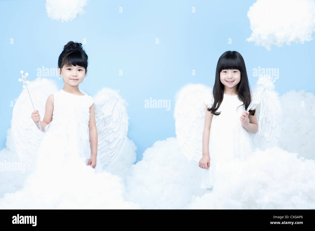 two little girls with looks of angels on the clouds Stock Photo - Alamy