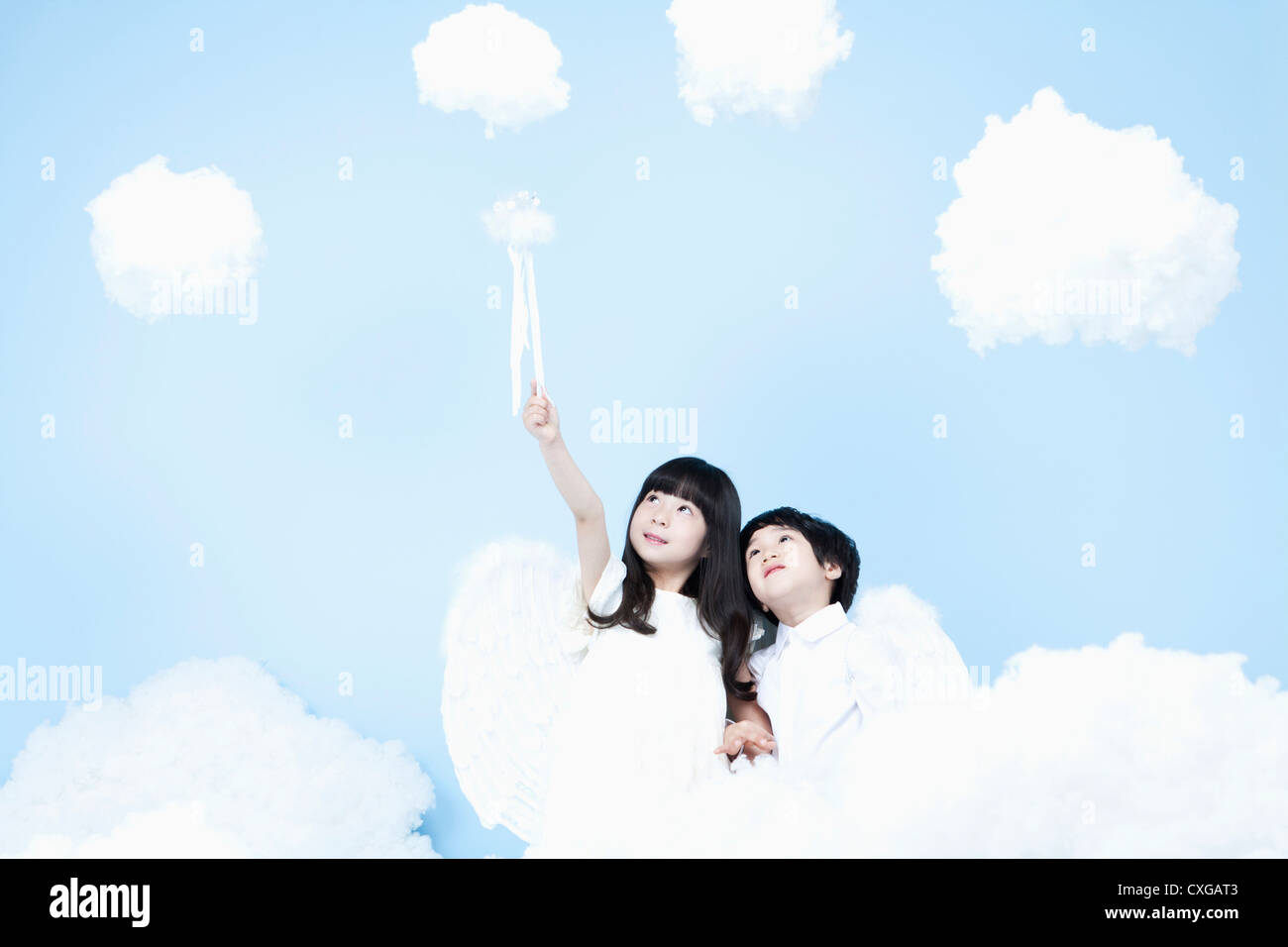 two kids with looks of angels on the clouds Stock Photo - Alamy