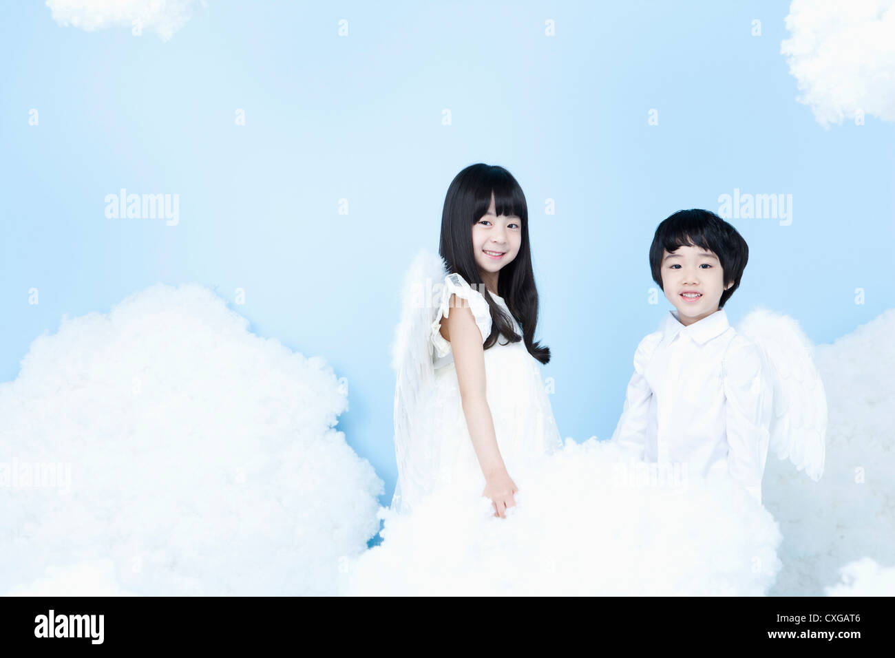 two kids with looks of angels on the clouds Stock Photo - Alamy