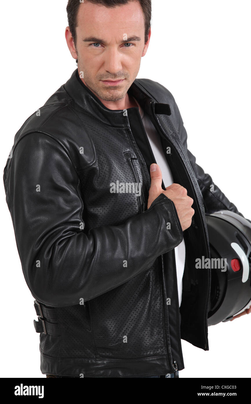 Biker holding jacket Stock Photo - Alamy