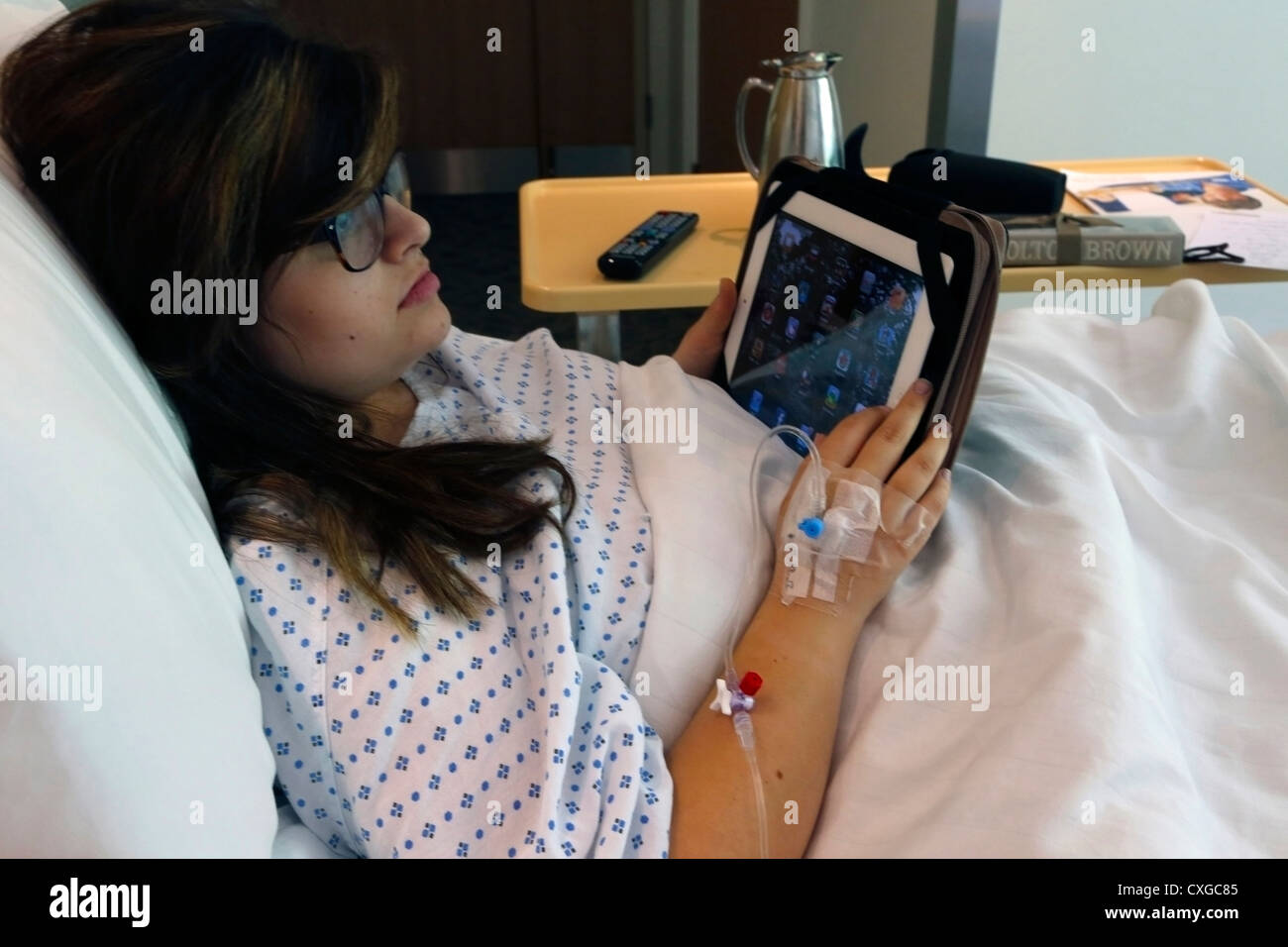 Patient With Cannula In Hospital Bed Working On iPad Ashtead Surrey ...