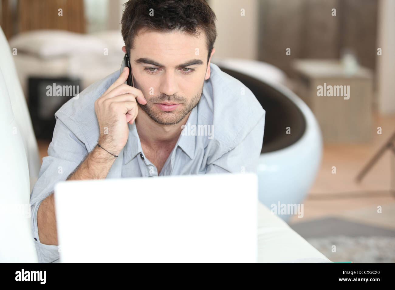 Man on the phone at the computer Stock Photo - Alamy