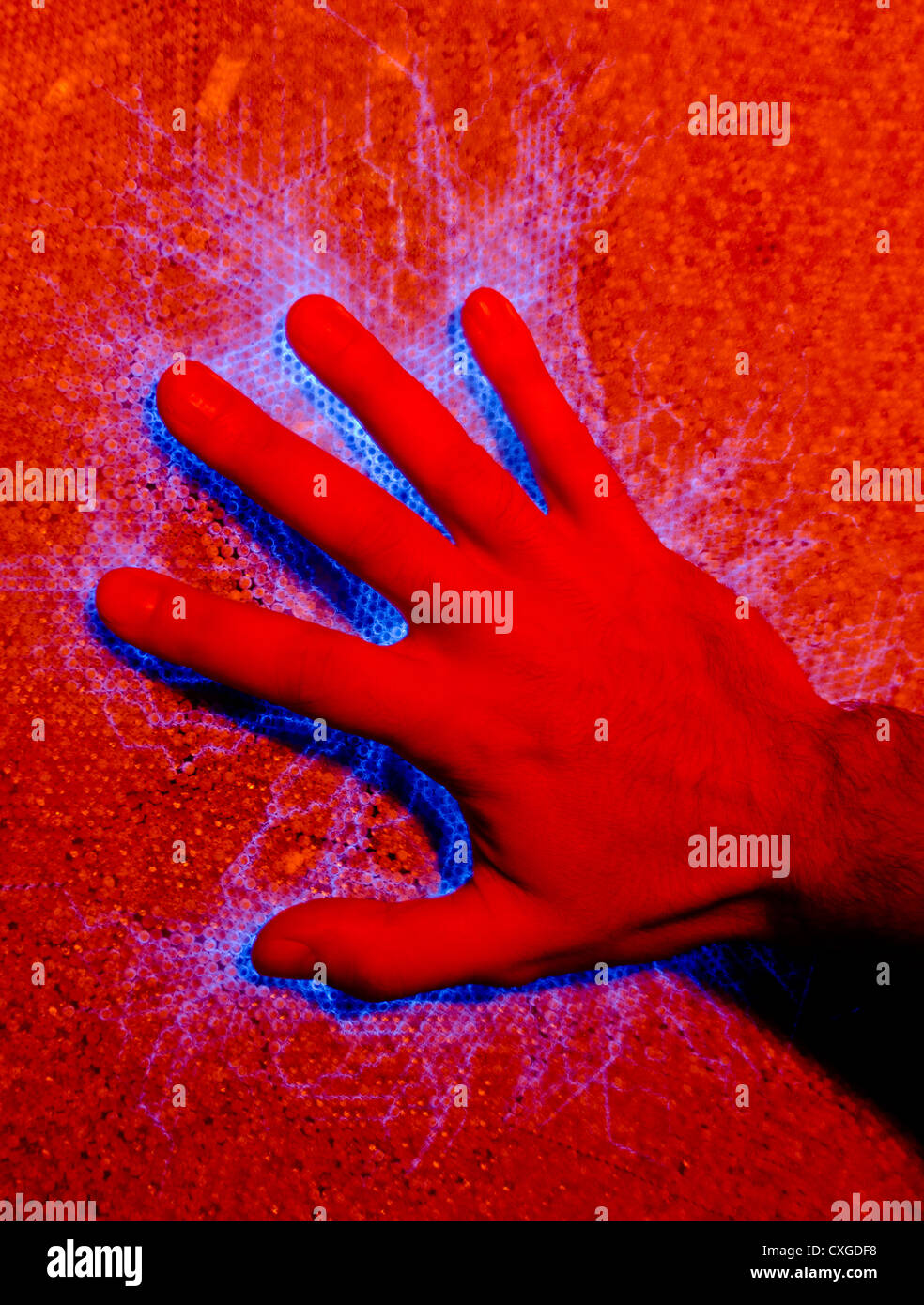 Hand on electricity charged surface creating blue sparks Stock Photo ...