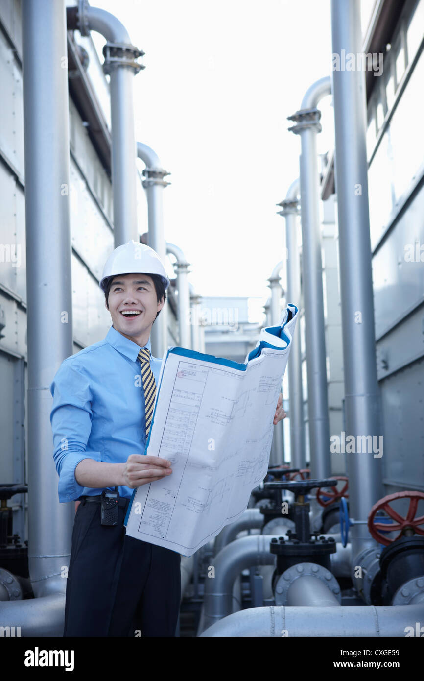 An architect wearing a suit laughing with portfolio in his hands Stock ...