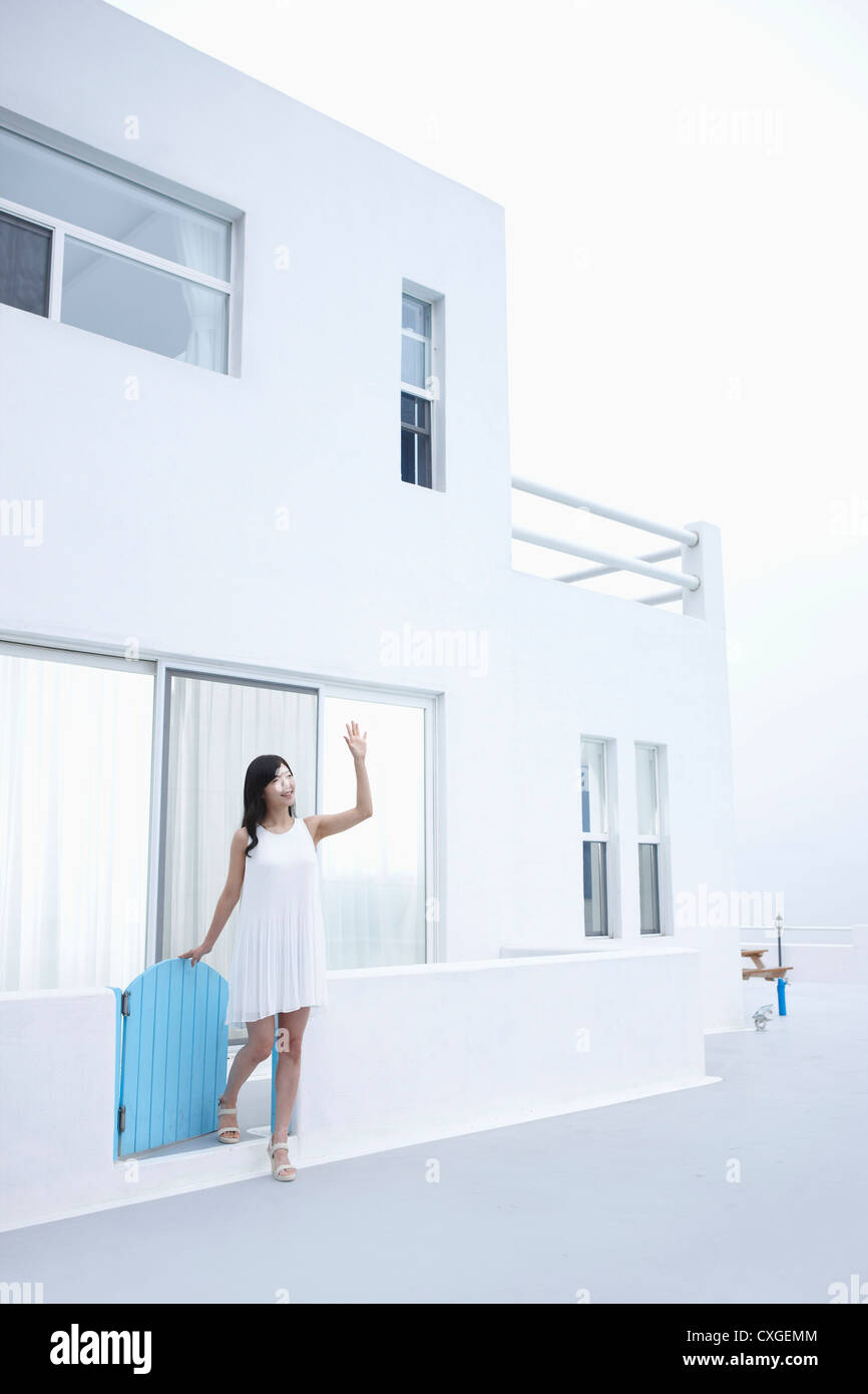 Woman coming out front door hi-res stock photography and images - Alamy