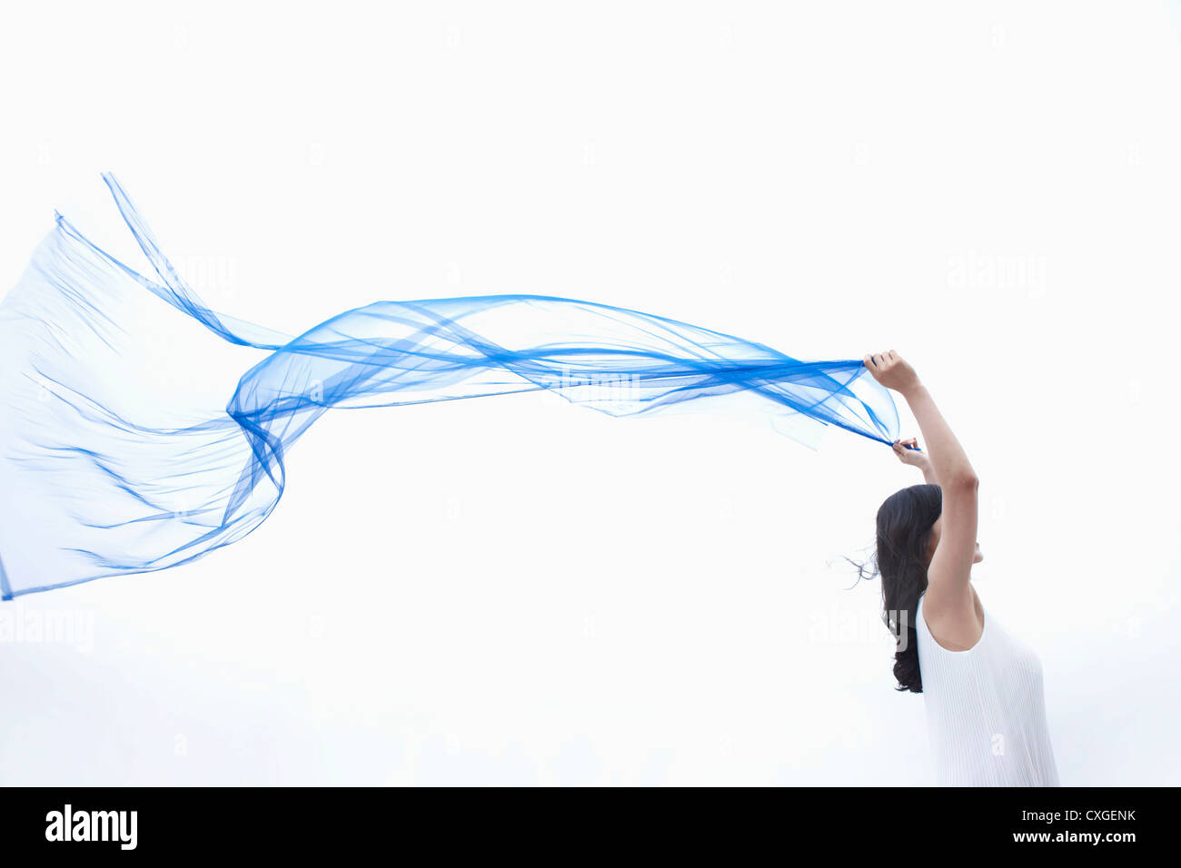 A woman holding up a thin linen in wind Stock Photo - Alamy