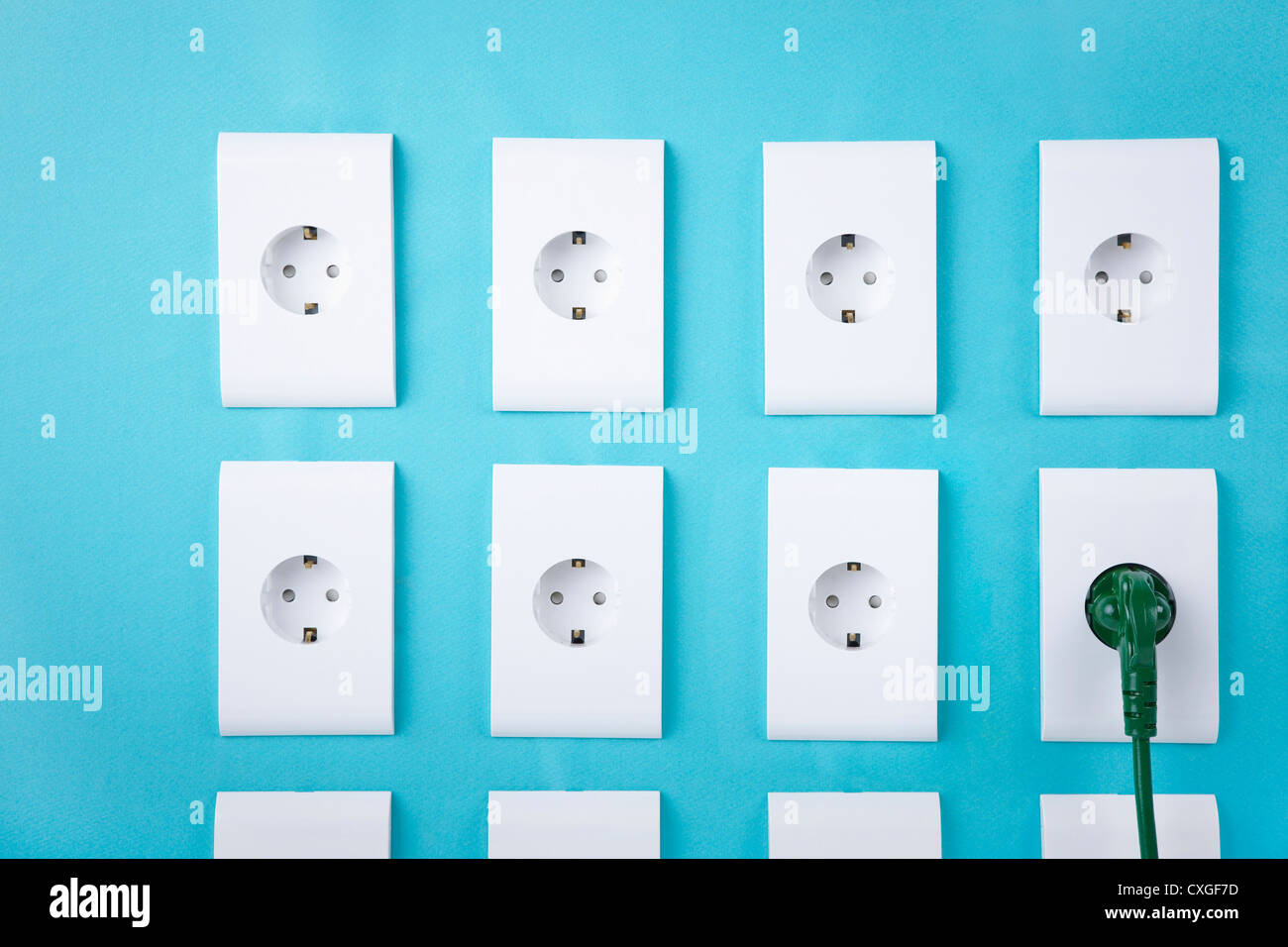 Electric outlets in three rows with a cord plugged in Stock Photo - Alamy
