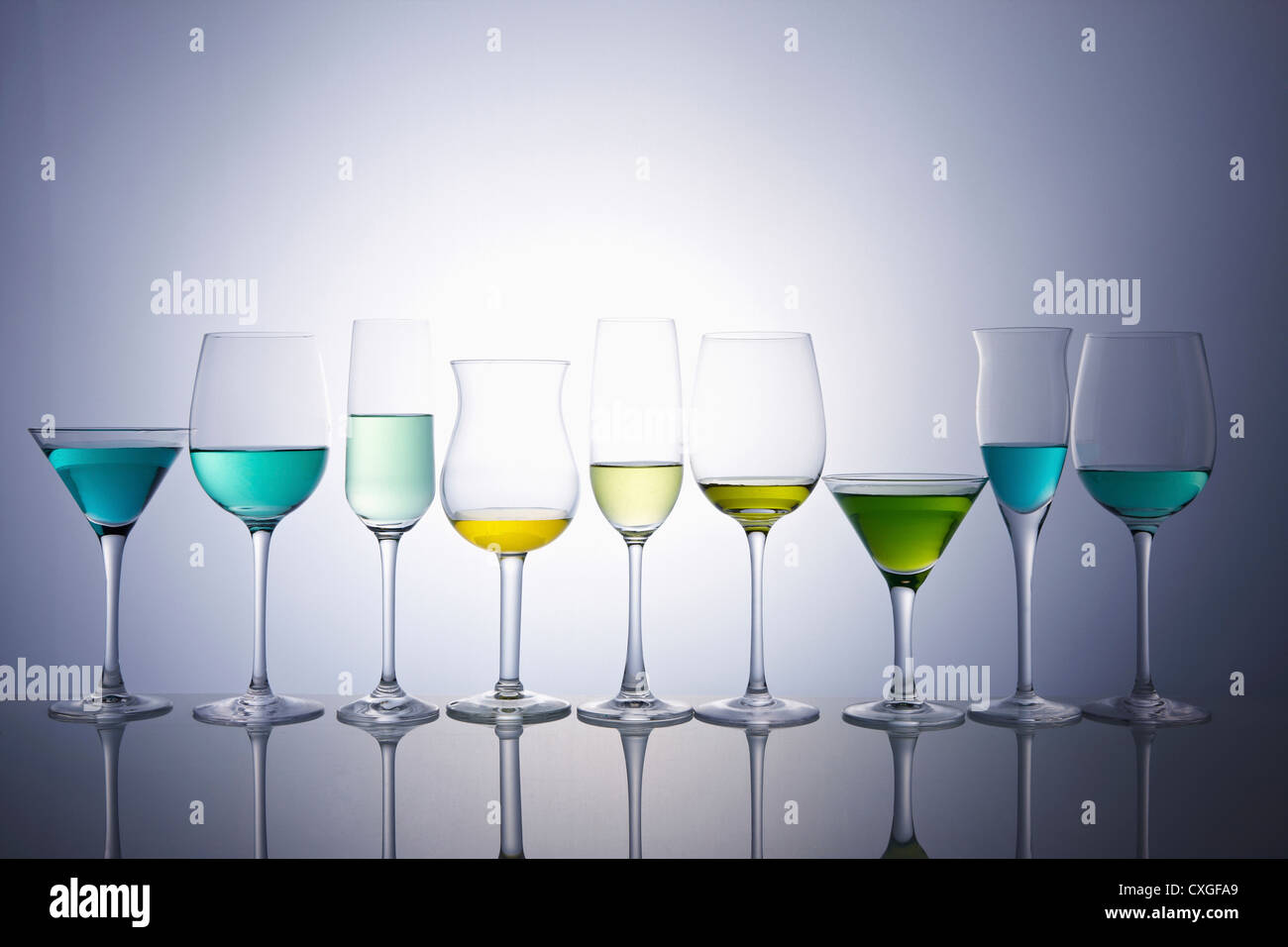 Wine Glasses In Different Size And Shape Filled With Colorful Cocktails