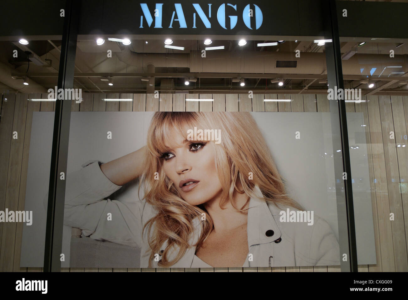 A poster of fashion model Kate Moss in a Mango shop window One New ...