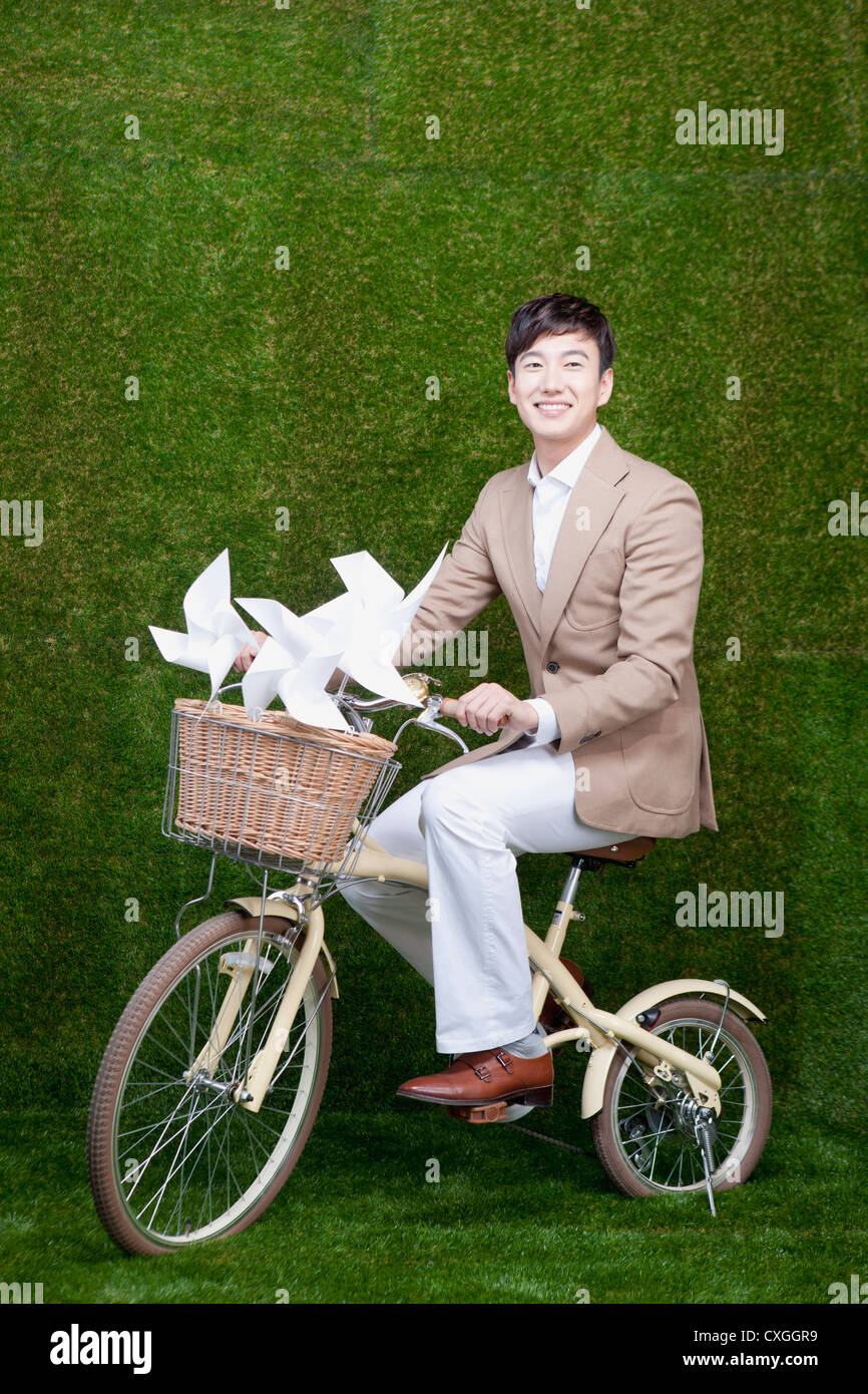 man riding a bike with pinwheel Stock Photo - Alamy